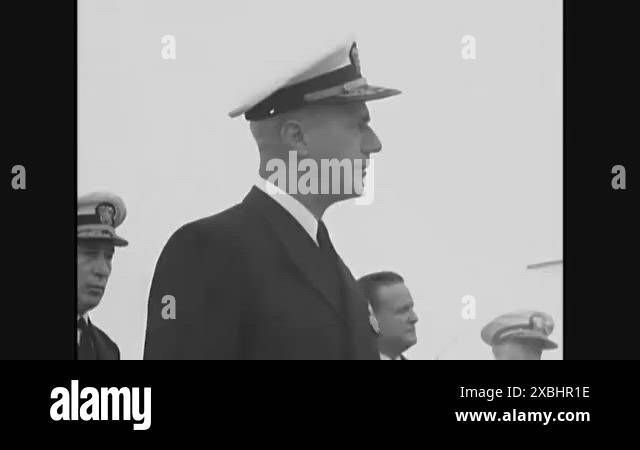 1954 - A Naval officer makes a speech at the commissioning ceremony of ...