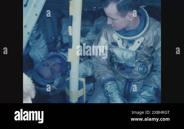 1960s - An escape pod with astronauts aboard is lowered into the ocean ...