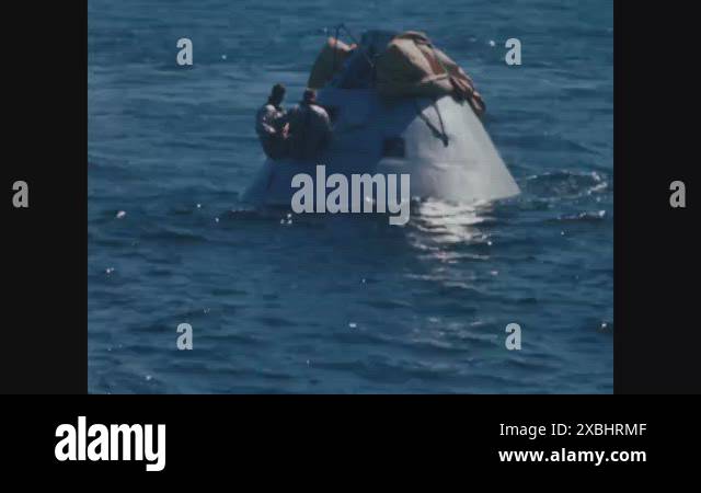 1960s - Astronauts inflate a lifeboat and climb out of the escape pod ...