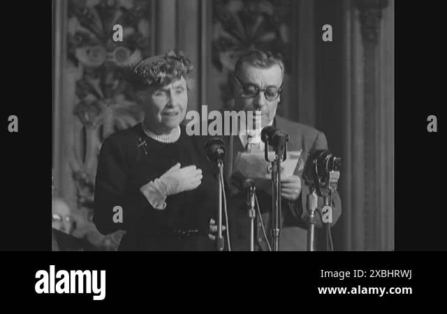Author Helen Adams Keller speaks with a presenter at her side at an ...