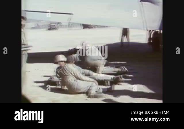 1942 - Airmen of the US Army Air Force wait by their aircraft on a base ...