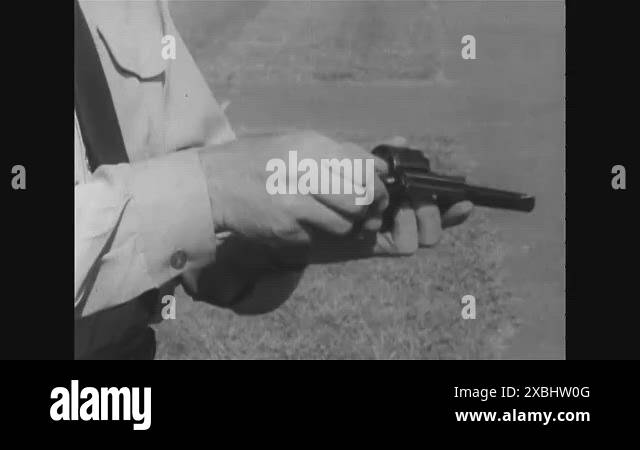 1960s - A policeman demonstrates how to load a service revolver Stock ...