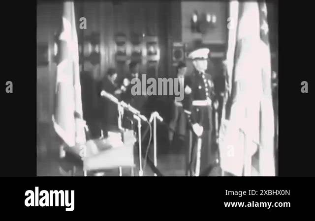 1964 - Soldiers and sailors stand guard as flowers are brought to ...