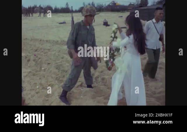 A United States Marine marries a Vietnamese woman on a beach as landing ...