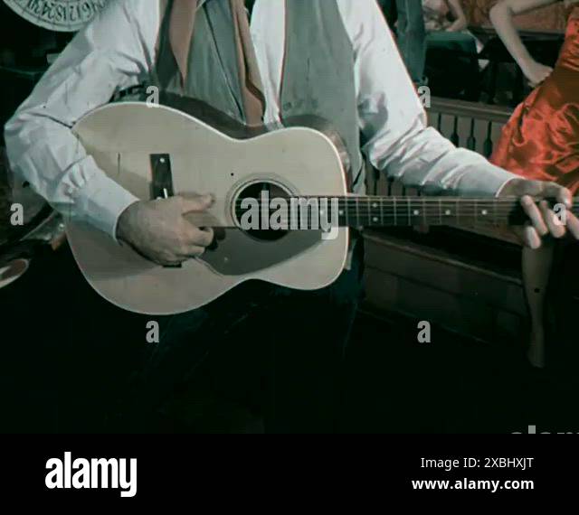 1965 - While gamblers play cards and spin wheels at an Old West saloon ...