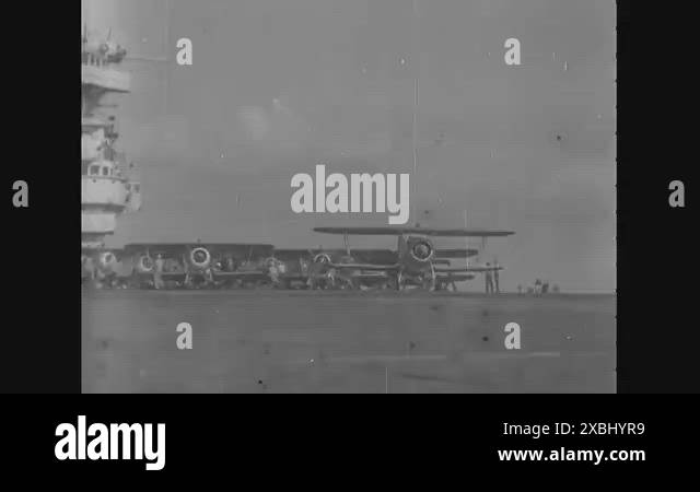 A warplane lands and biplanes are shown taking off from a United States ...