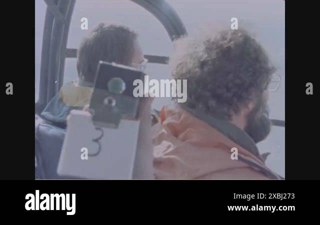 1980s - Scientists talk animatedly in an aircraft as it flies towards ...