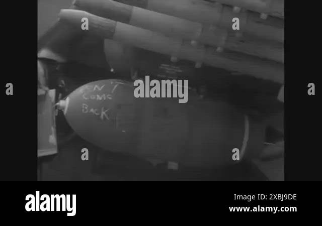 1950 - Plane handlers on the USS Boxer move an aircraft loaded with ...