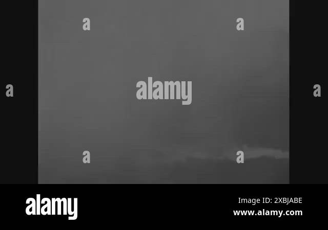 Coves and inlets are shown as well as warships and landing craft during ...