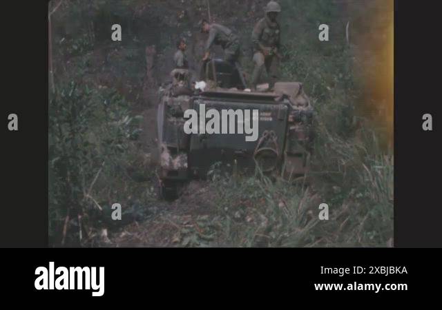 1969 - American soldiers try to pull a tank out of the mud, stuck in ...