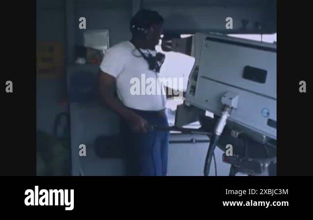 1973 - A US Navy sailor operates a camera on the USS Lexington Stock ...