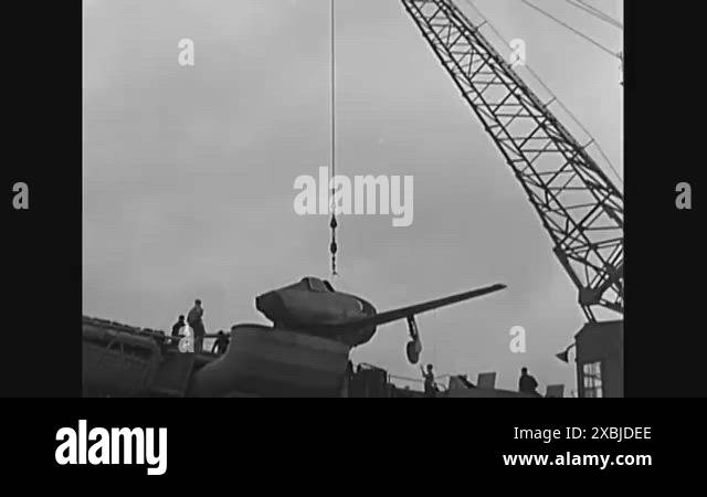 1940s - A crane is used to hoist a plane off a US Navy aircraft carrier ...