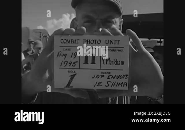 1945 - US Army guards and spectators stand by at Ie Shima Airfield ...