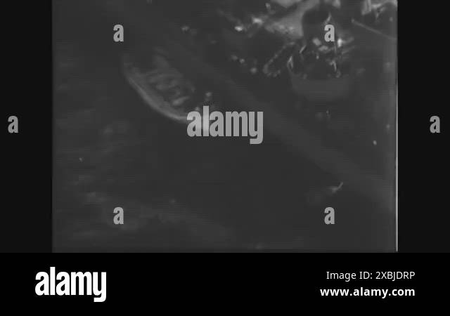 1940s - Aerial footage shows passengers getting into lifeboats from a ...