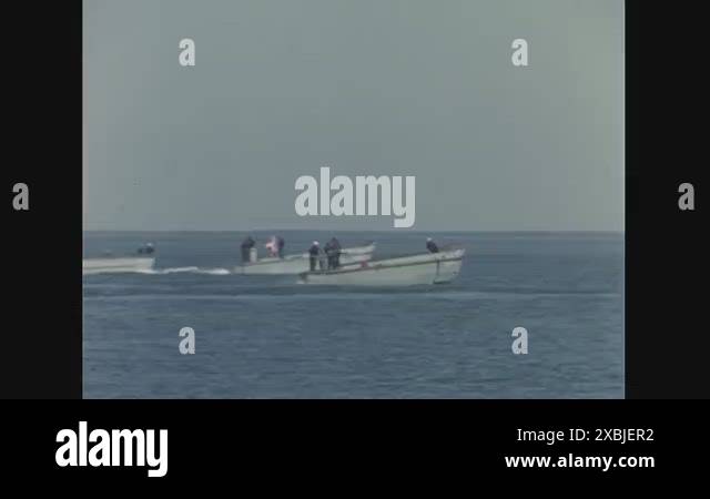 Higgins boats and Landing Craft Personnel Large watercraft move in a column and make circles at ...