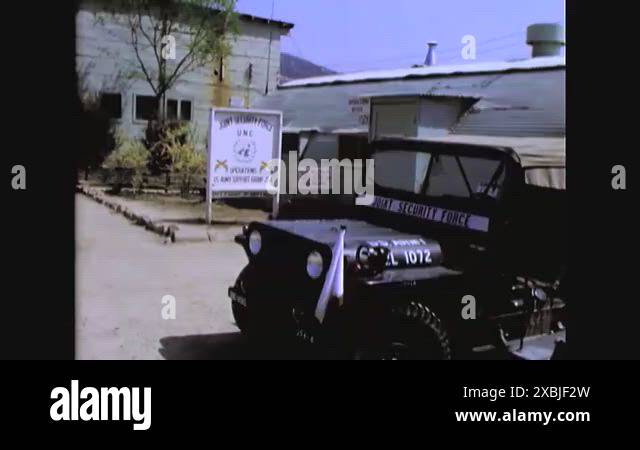 A military policeman exits a quonset hut and a Joint Security Force ...