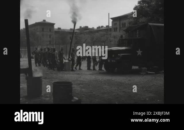 United States Army soldiers are served in a food line and they are ...