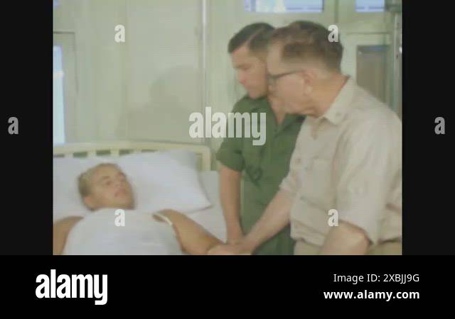 1968 - Vice Admiral Burkley visits a wounded airman in Vietnam and ...