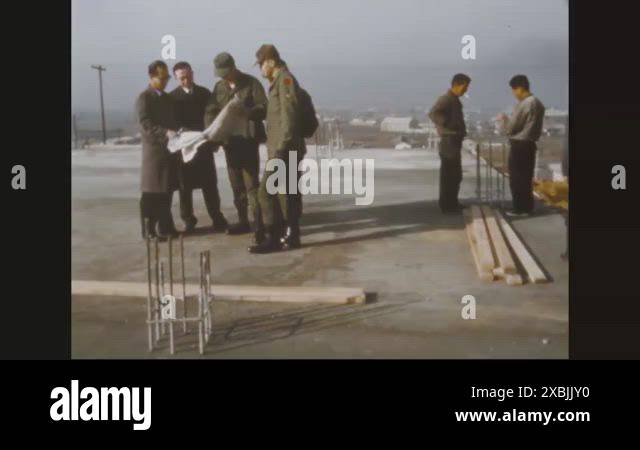 1968 - American soldiers and Korean construction workers go over ...