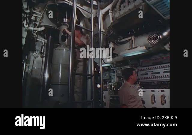 1970 - Officers aboard the USS Grayback are shown using the periscope and intercom Stock Video ...