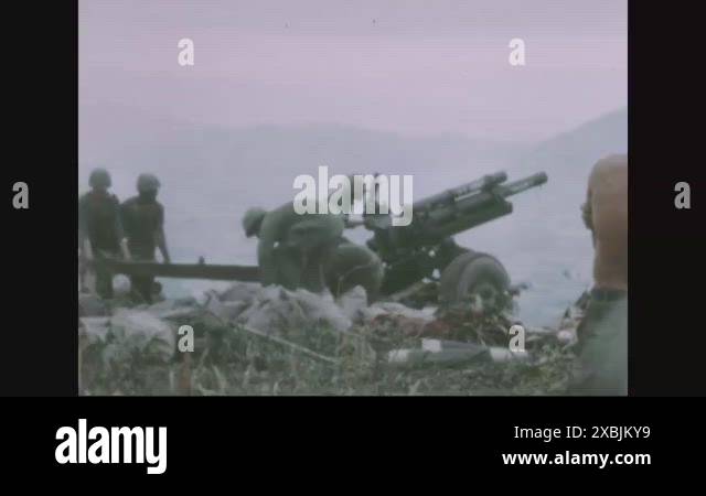 1968 - American soldiers set up a 105mm Howitzer on a mountaintop in ...