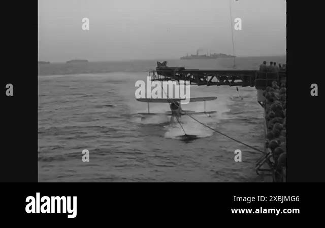 1943 - Biplanes are lifted from a recovery mat to the catapult on a US ...