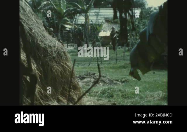 1968 - American soldiers search huts in Vietnam and cross a shallow ...