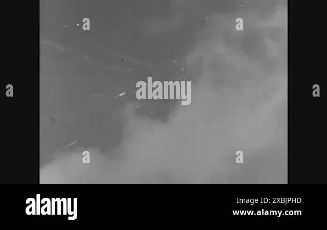 Antiaircraft fire is shown and a wounded sailor and an officer are ...
