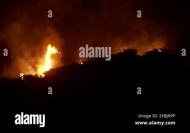 Firefighters battle a raging California wildfire at night by performing ...