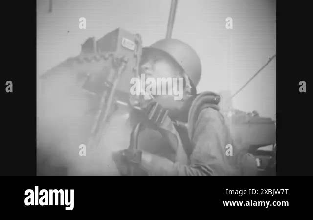 Soldiers fire naval guns and a damage is shown aboard a warship at sea ...