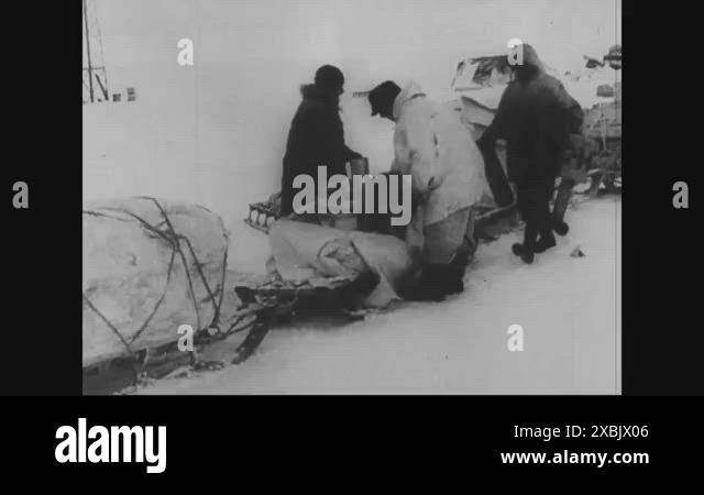 1934 - At the South Pole, Admiral Byrd goes over a map of a planned ...