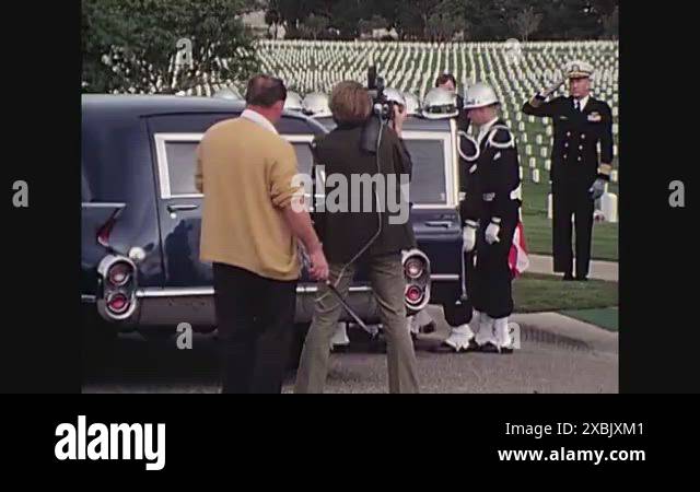 Cameramen photograph the honor guard as they carry the casket to the ...