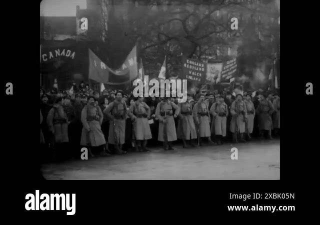 1919 - A crowd holds flags from various countries attending the Treaty ...