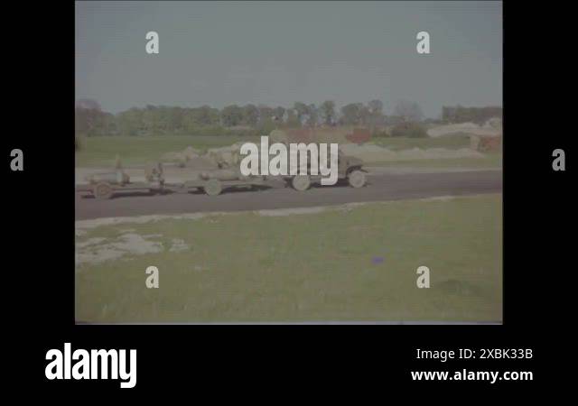 1940s - Bombs are transported by trailer to the planes on the runway ...