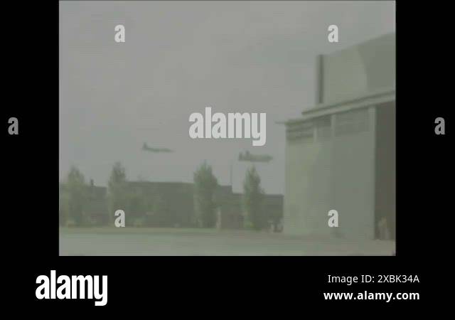 1940s - An aircraft hangar, heavy wind blowing through trees, and a ...