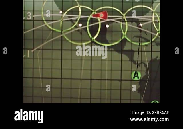 1962 - Aerospace engineers sit at control panels and communicate with ...