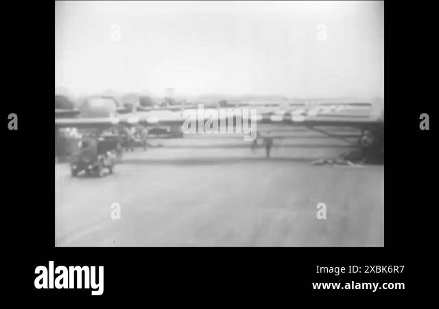 1944 - Airmen load cargo into planes, prepare plans for a mission, and ...