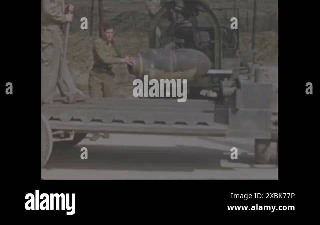 1943 - A bomb is loaded and stacked bombs are shown as well as a ...