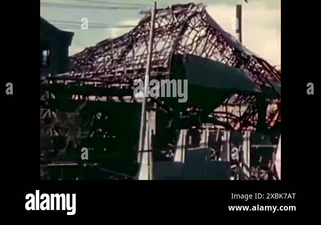 1945 - A collapsed plant and smokestacks are shown in the aftermath of ...