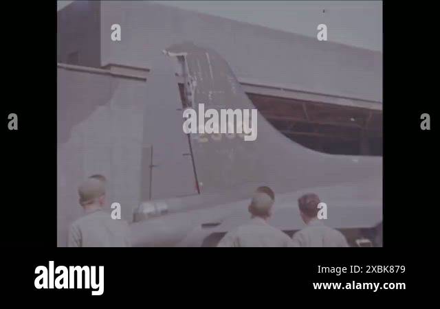 1943 - Mechanics survey damage to the tail of the Memphis Belle, a ...