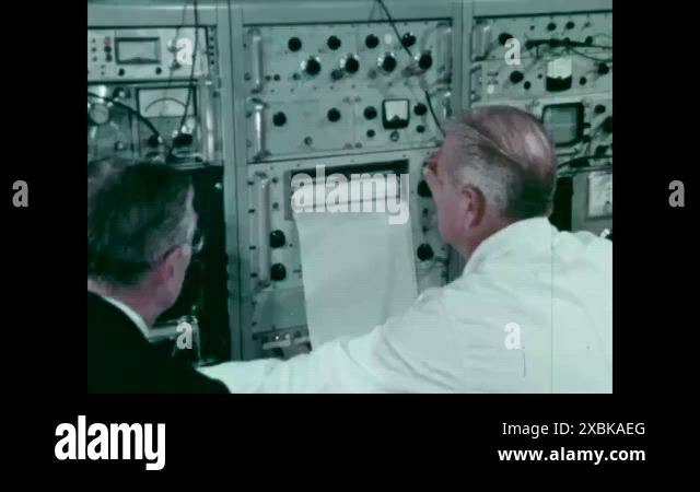 1970 - An acoustician studies a printout of sound frequencies at the ...