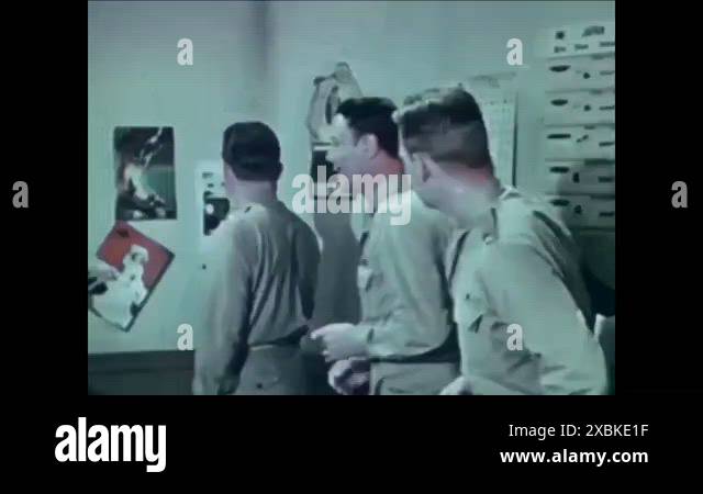 Camouflage officers look at an ammunition dump pictured in a map and ...
