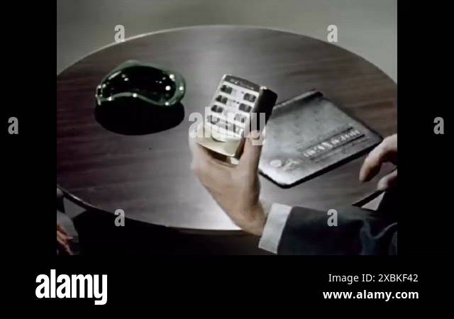 1959 - A man shows a woman how her new remote control can be used to ...