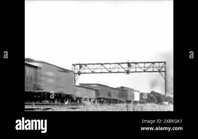 A train travels and a searchlight casts light beams through colored ...