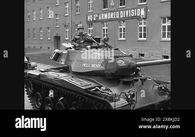 The 2nd Armored Division leaves headquarters in tanks and children wave ...