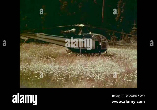 A United States Forest Service team is flown in a helicopter over ...