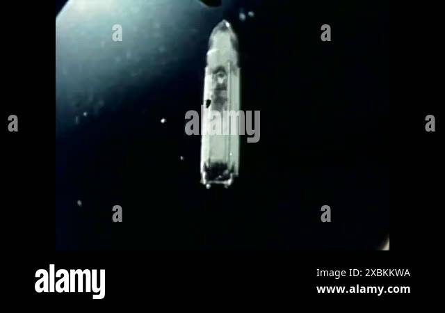 Astronaut Robert Laurel Crippen puts his helmet in a bag in the ...