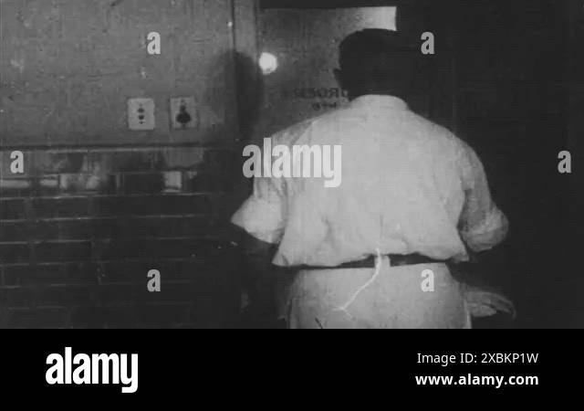 Orderlies roll an anesthetized patient into an operating room and an ...