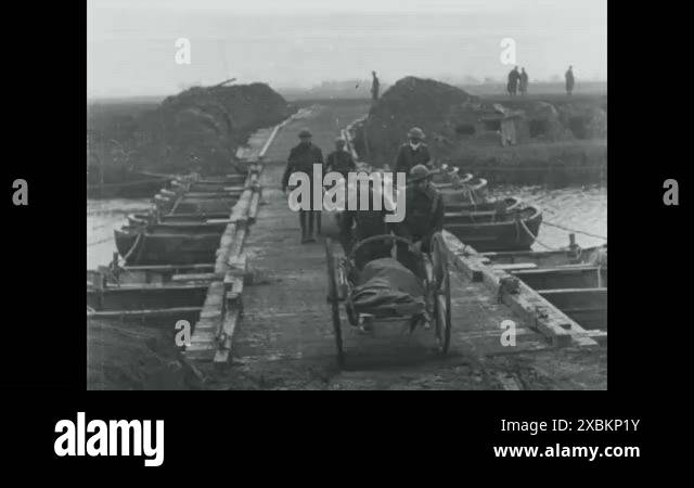 37th Division medics and stretcher bearers cross a pontoon bridge over ...