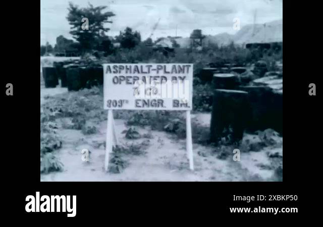 An asphalt plant is shown as well as a steamroller as engineers in the ...